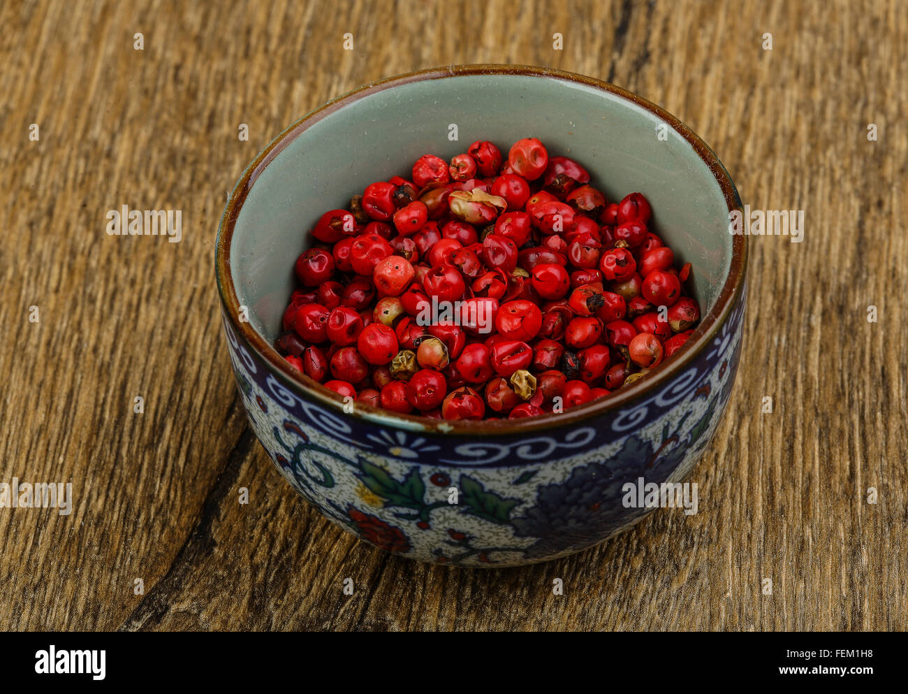 Dry Rose pepper corn on the wood background Stock Photo - Alamy