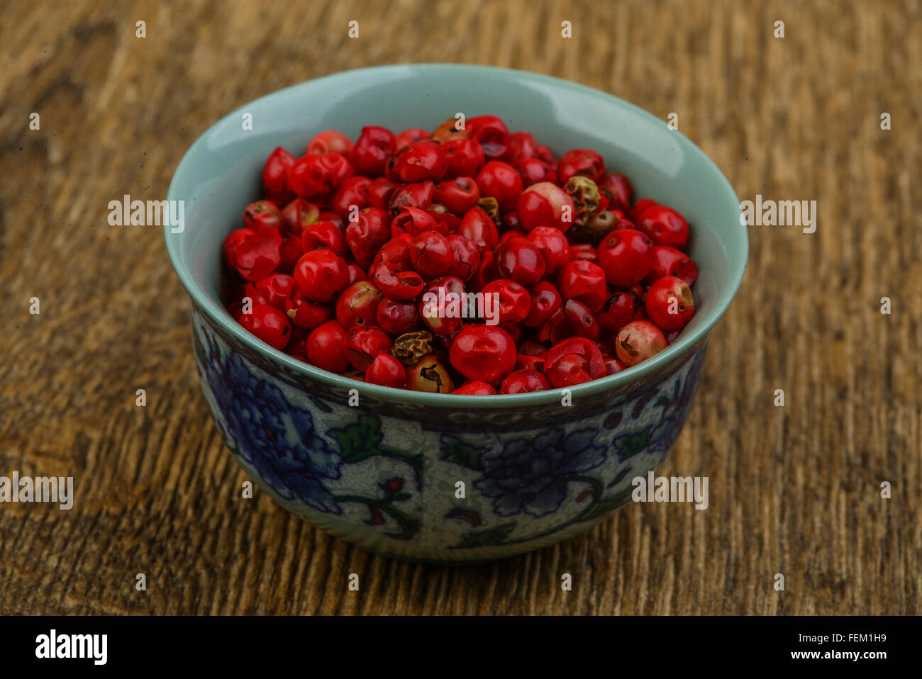 Dry Rose pepper corn on the wood background Stock Photo - Alamy