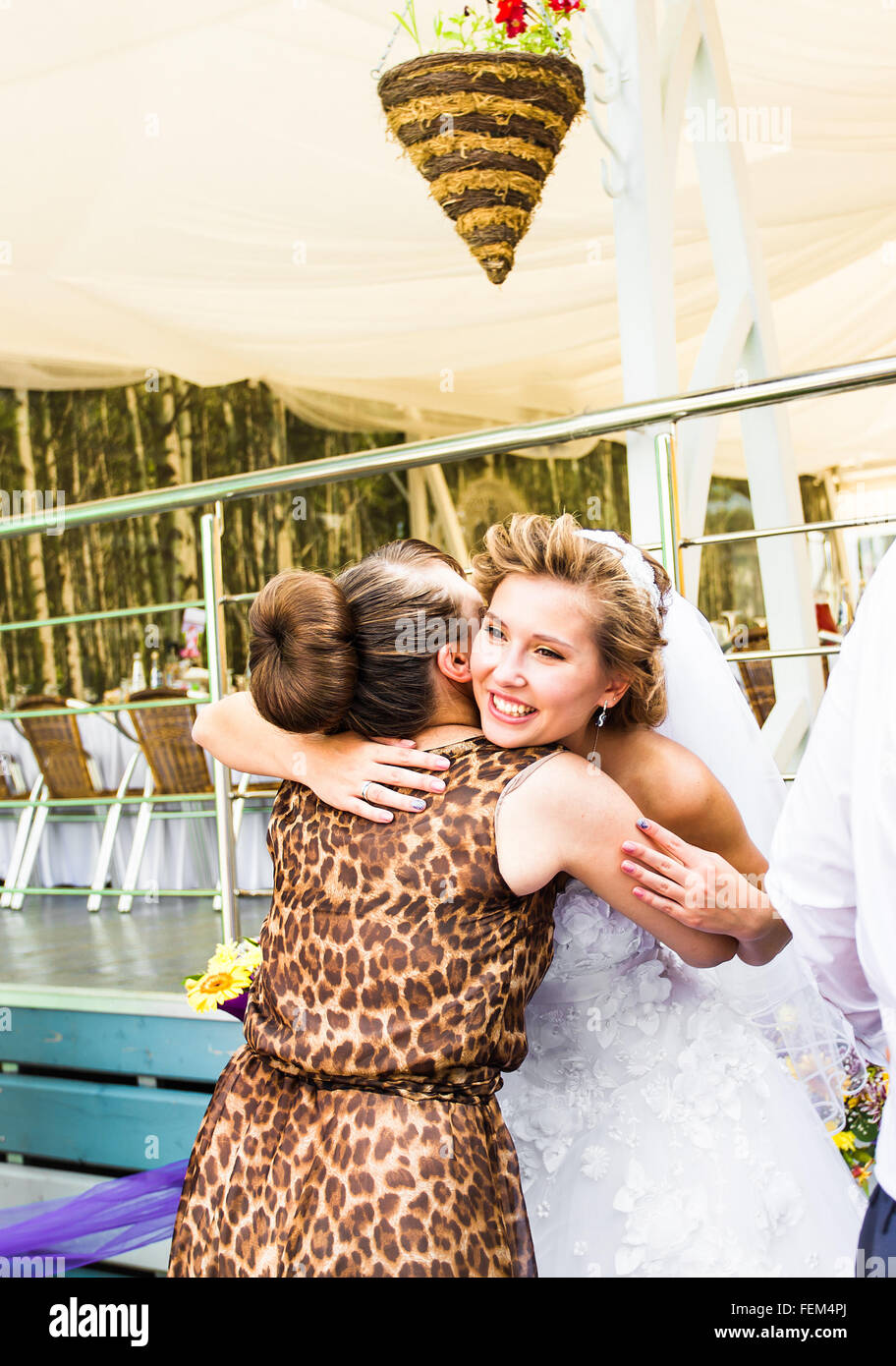 Bride Hugging Sister On Wedding Day Stock Photo - Alamy