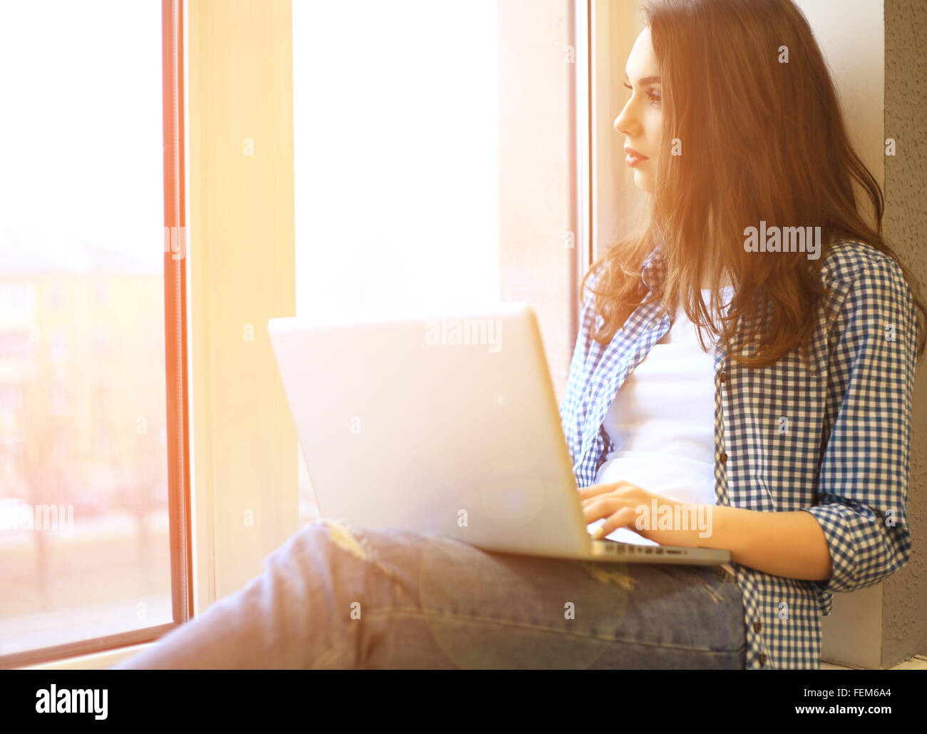 Girl working on computer in light room Stock Photo - Alamy