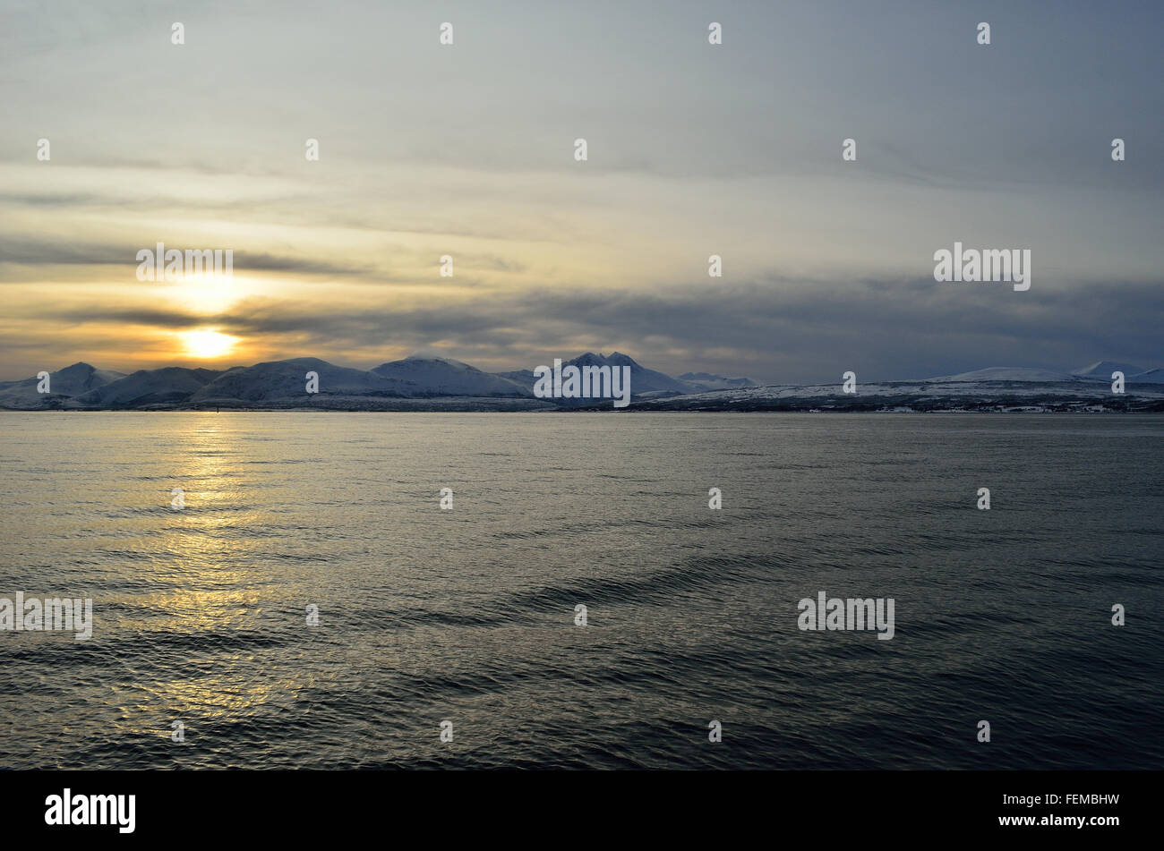 beautiful sunset over snowy mountain and fjord Stock Photo - Alamy