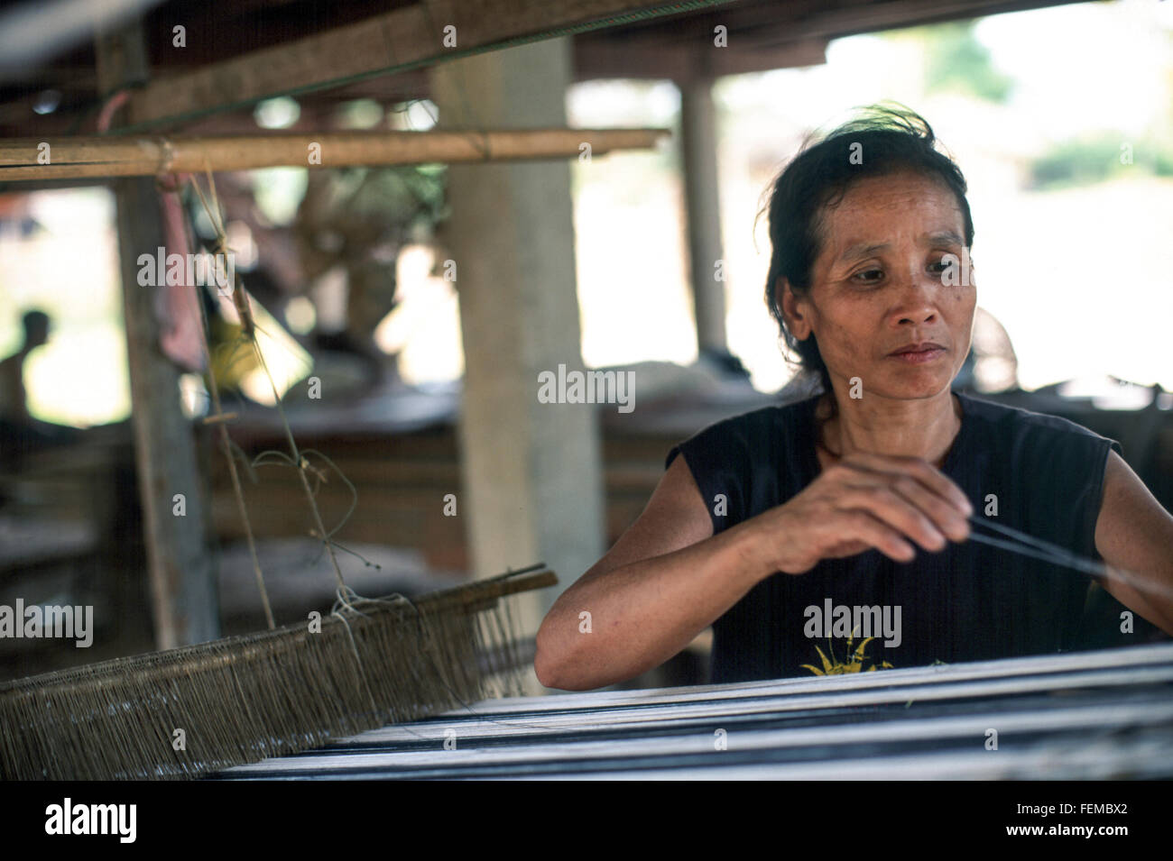 Woman weaving on traditional authentic wooden foot operated loom in an ...