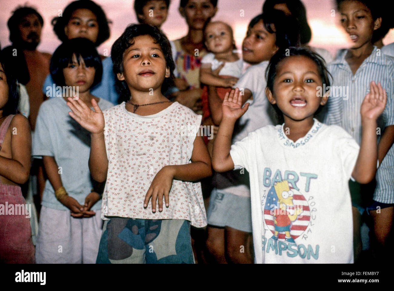 Young girls at school in the Philippines sing and clap during a lesson ...
