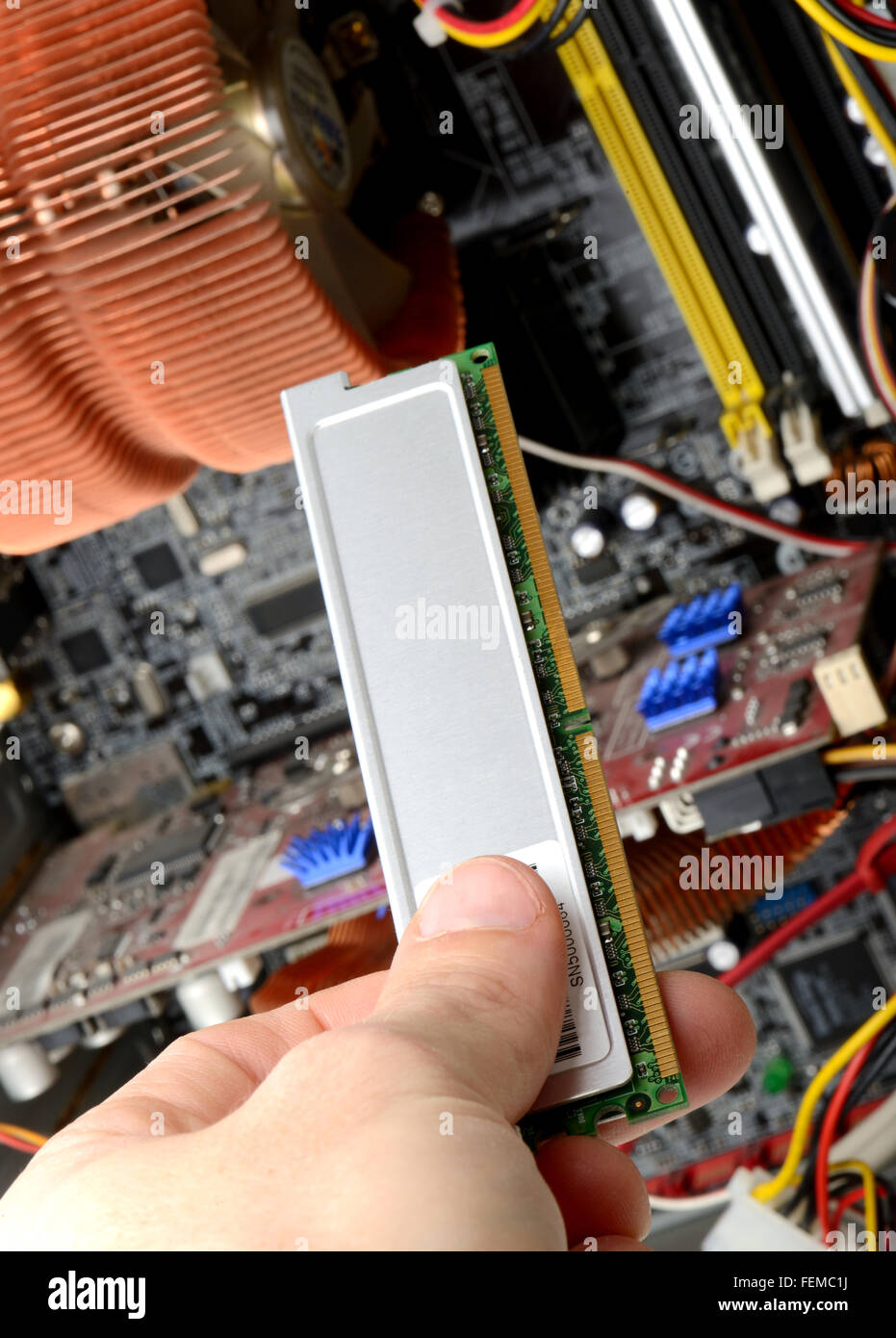 Hand installing ram memory upgrade Stock Photo - Alamy