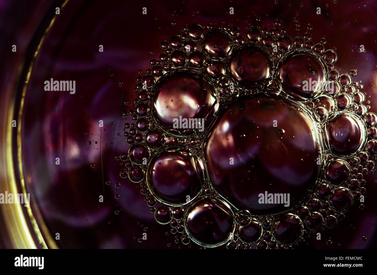dark purple abstract bubbles made of oil in water surface Stock Photo ...