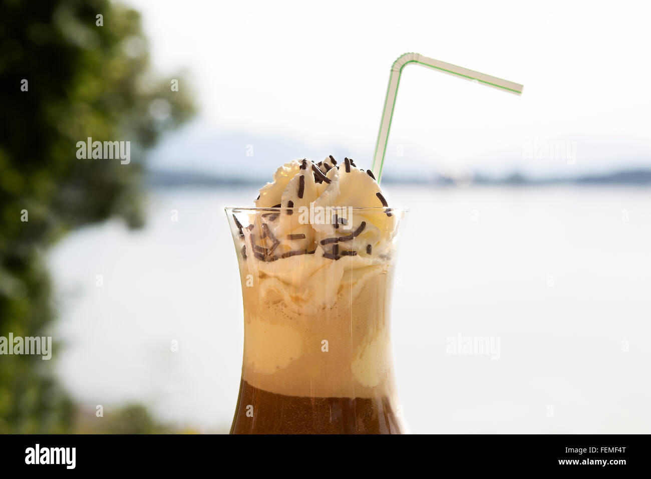 Iced coffee in summertime at a restaurant near a lake Stock Photo - Alamy