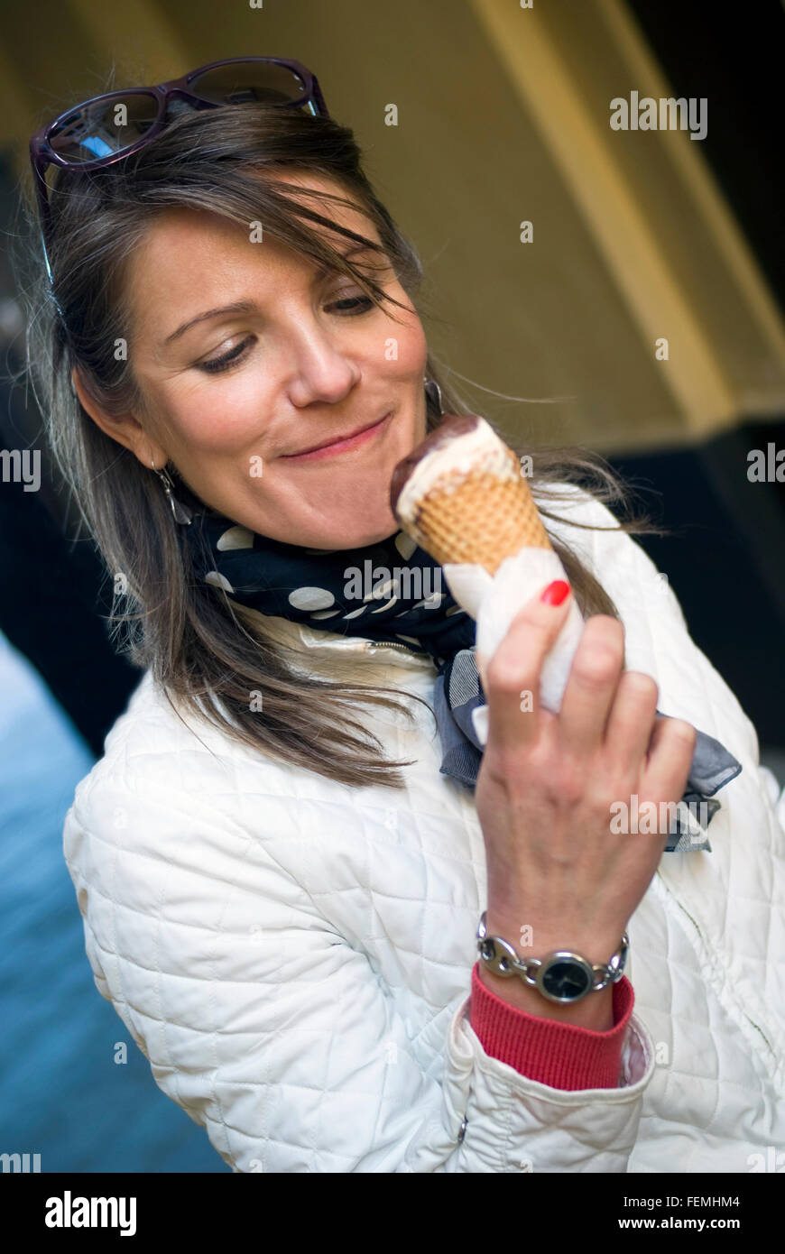Woman outdoors, eating an ice cream Stock Photo - Alamy