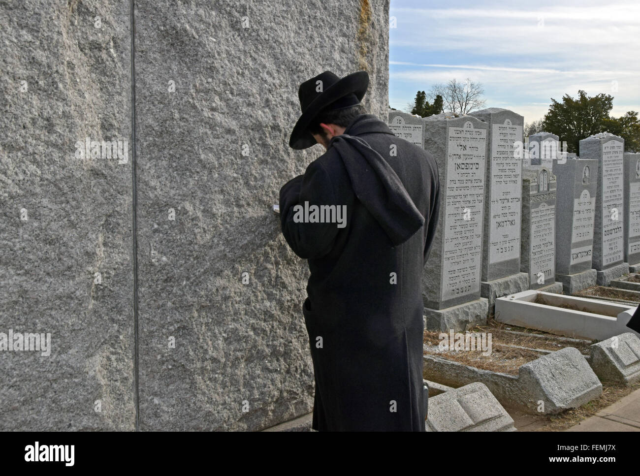 An anonymous religious Jewish man prays adjacent to the Ohel in ...