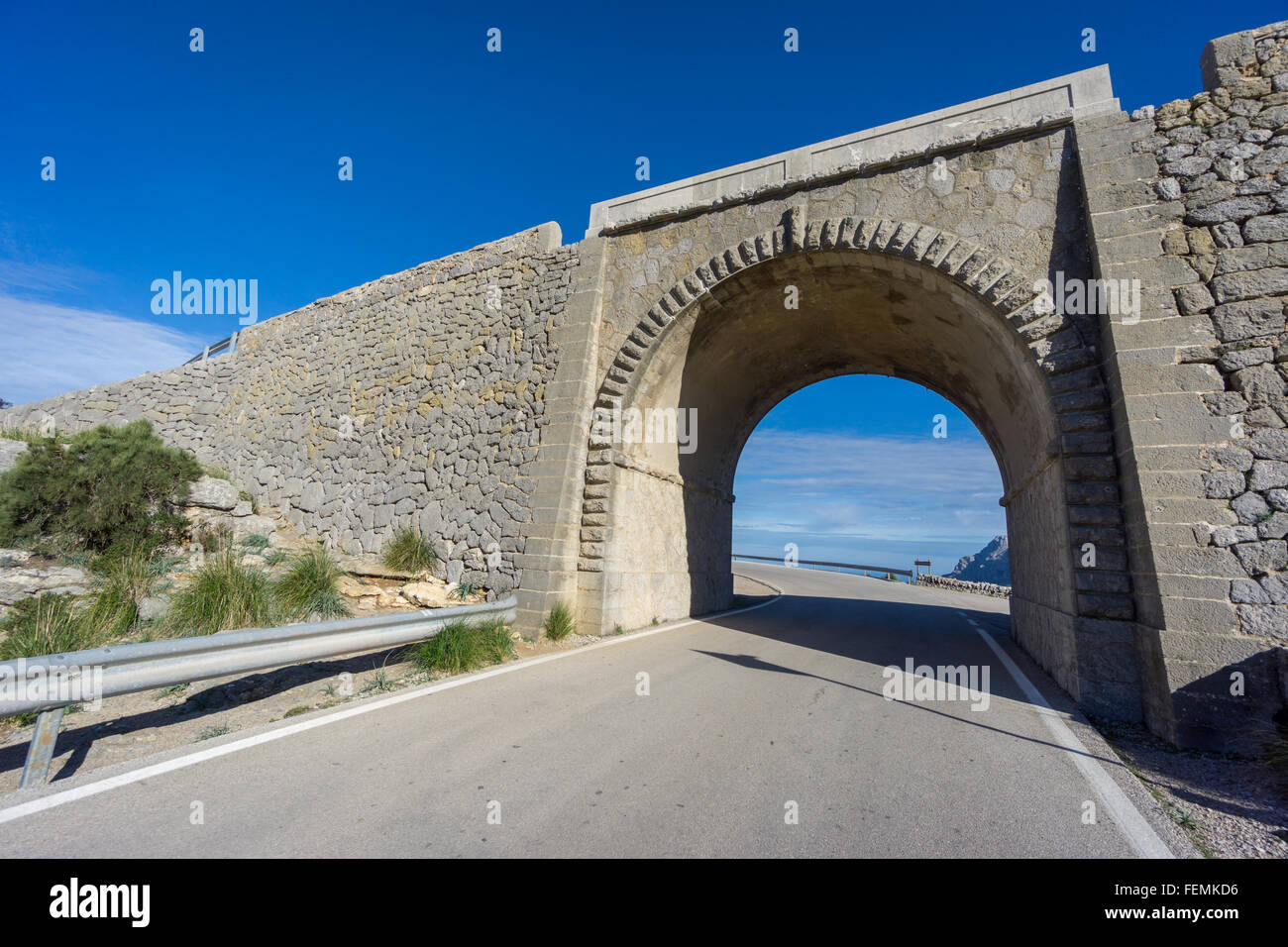 Curved road under bridge Stock Photo - Alamy