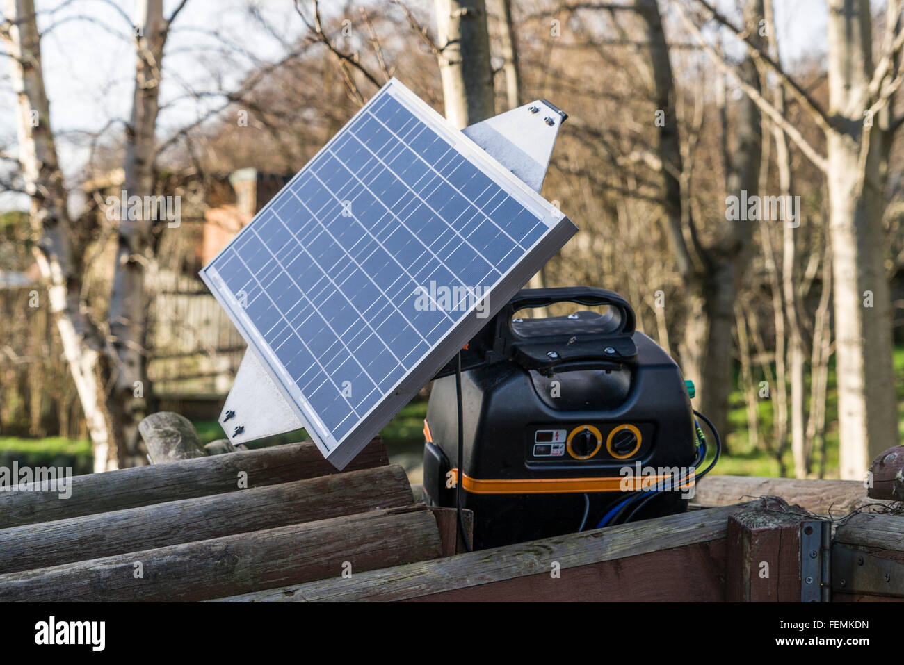 Solar panel powers a small generator and battery in an animal enclosure ...