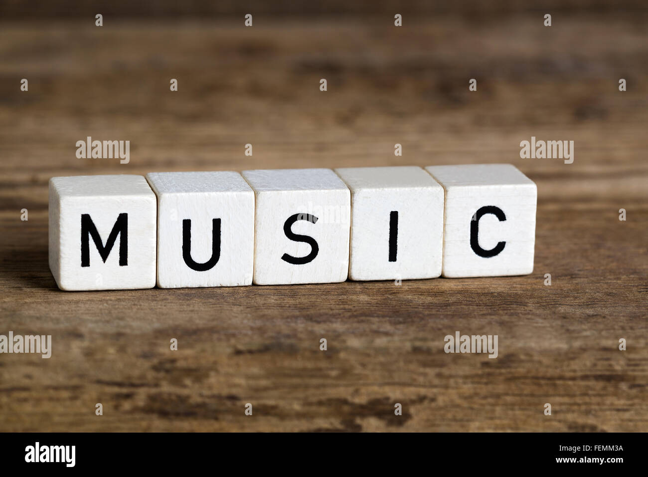 The word music written in cubes on wooden background Stock Photo - Alamy