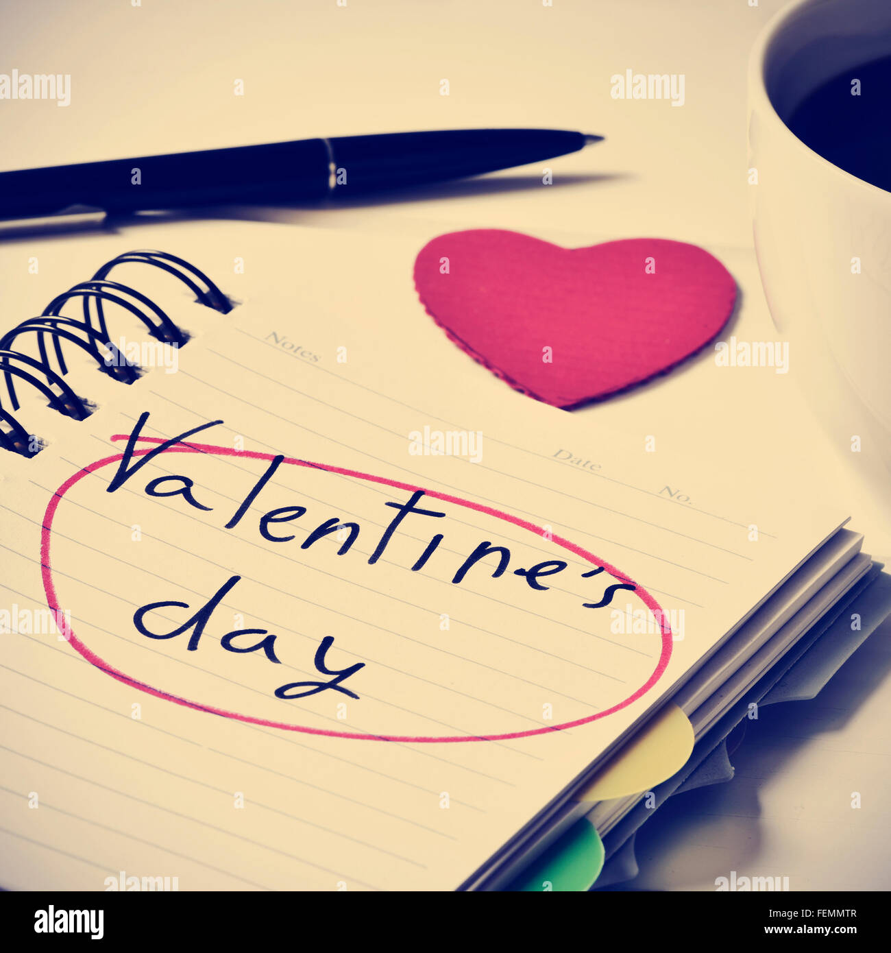 closeup of a notebook with the text valentines day handwritten in it, a ...