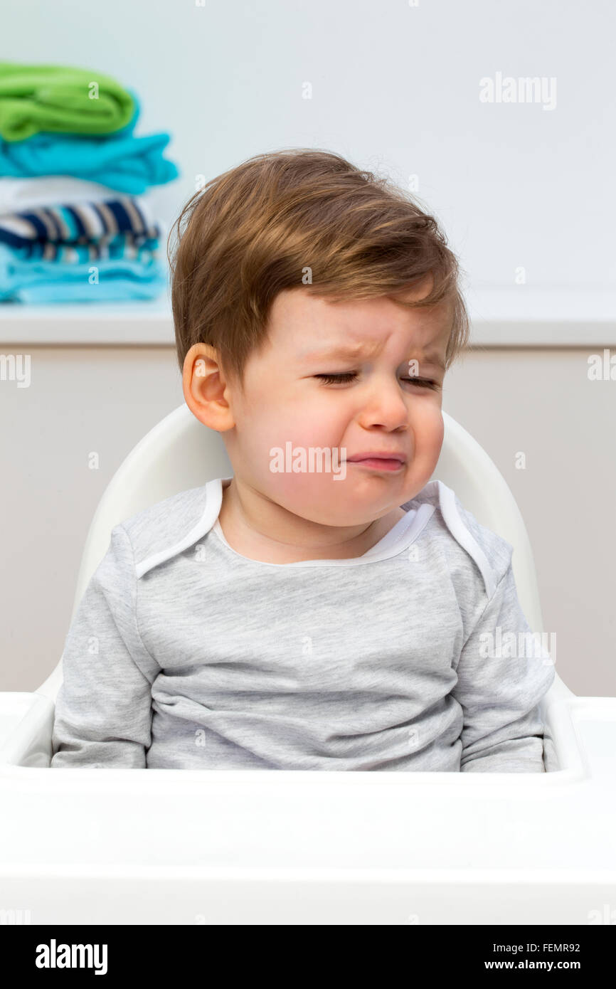 Baby boy looking upset hi-res stock photography and images - Alamy