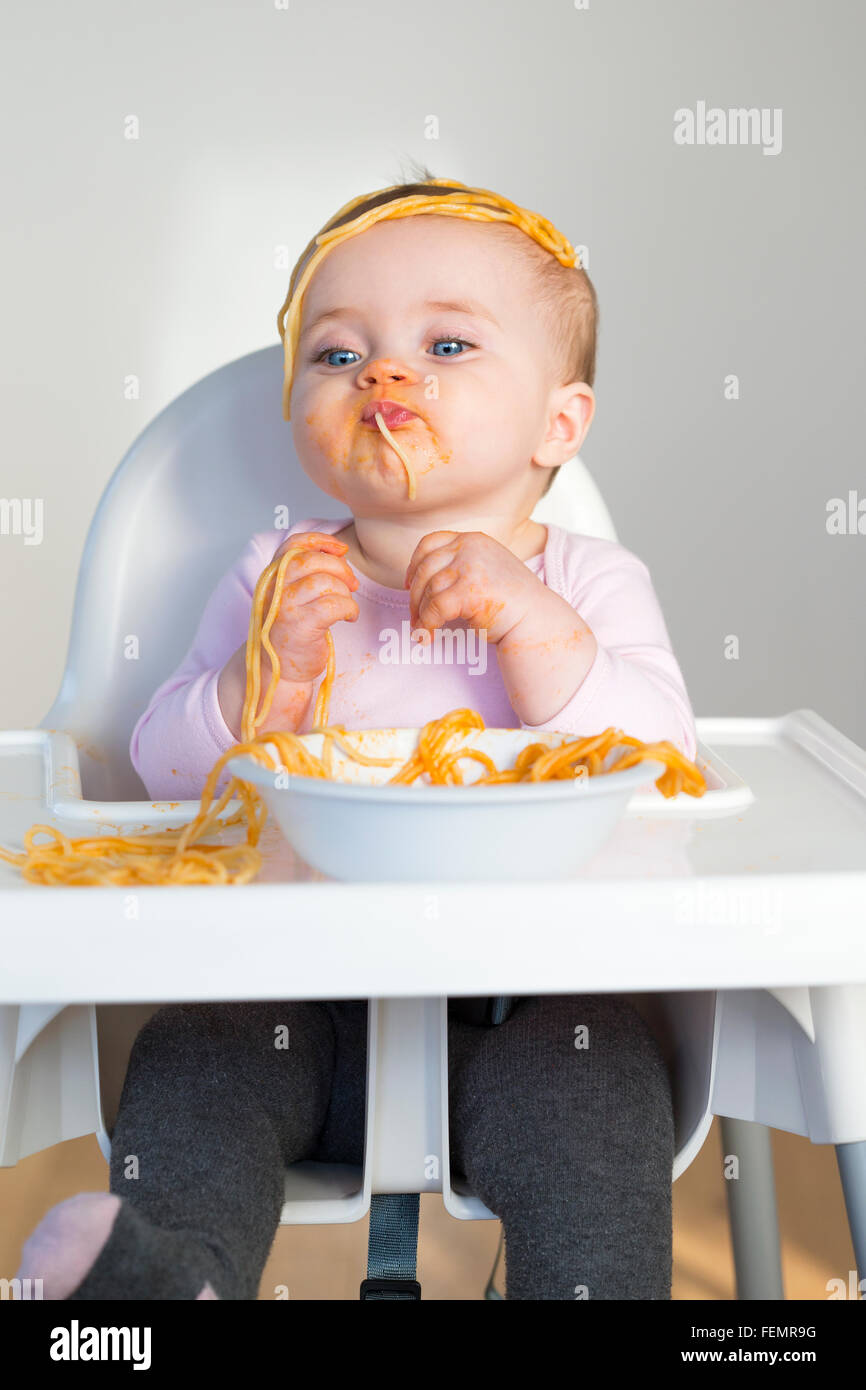 Little Girl Eating her dinner and making a mess Stock Photo - Alamy