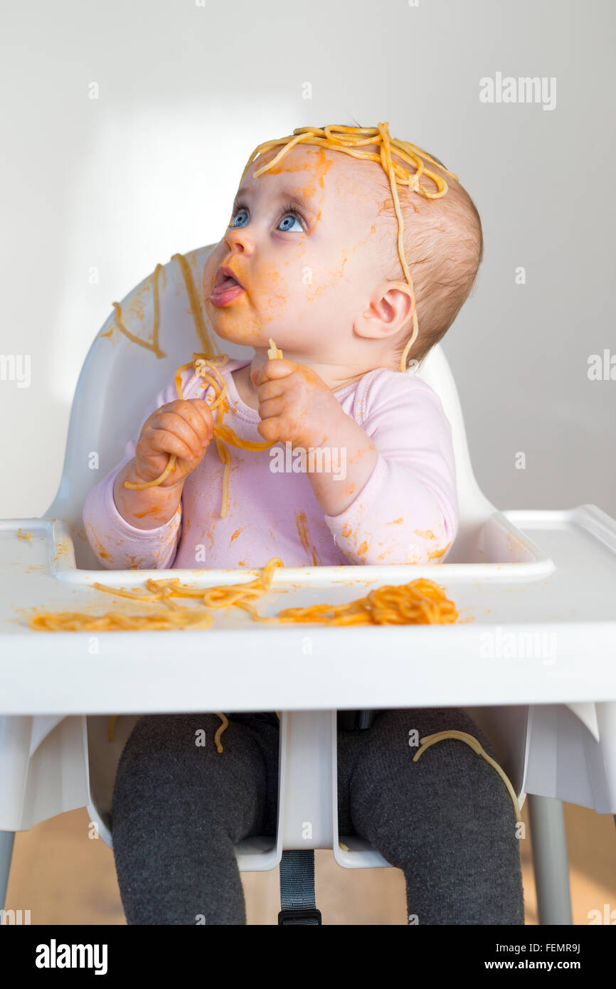 Little Girl Eating her dinner and making a mess Stock Photo - Alamy