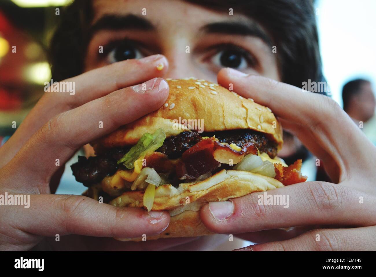 Teenage Boy Eating Hamburger Stock Photo - Alamy