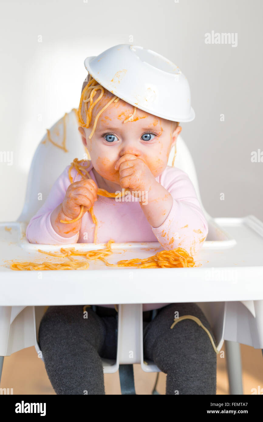 Little Girl Eating her dinner and making a mess Stock Photo - Alamy