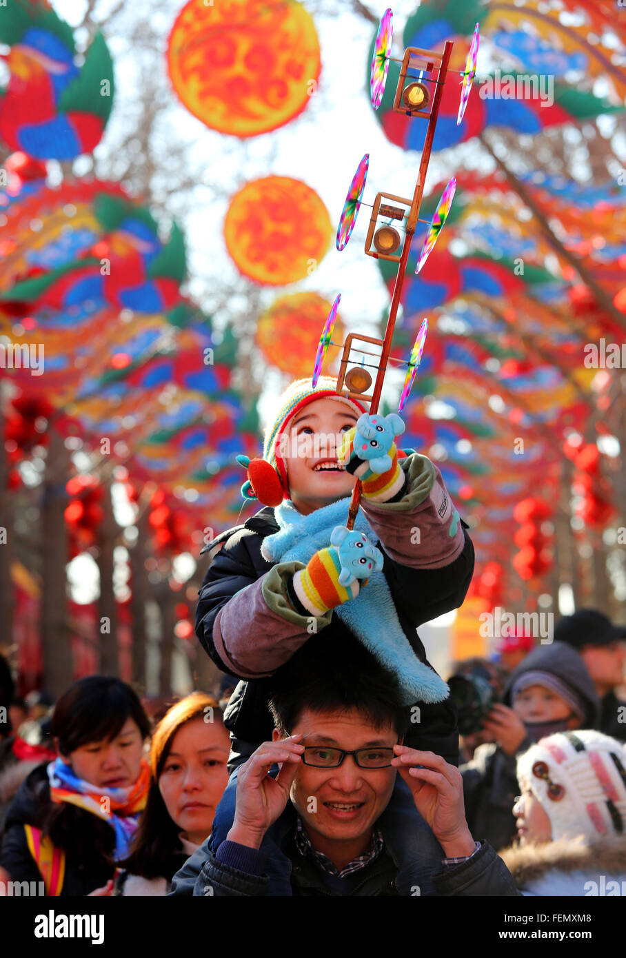 Beijing, China. 8th Feb, 2016. A child with a pinwheel enjoys a ...
