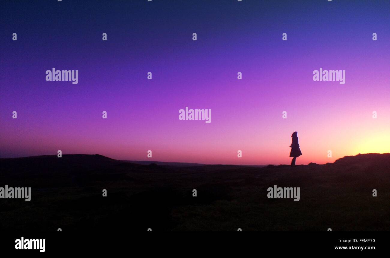 Woman standing on the rocks hi-res stock photography and images - Alamy