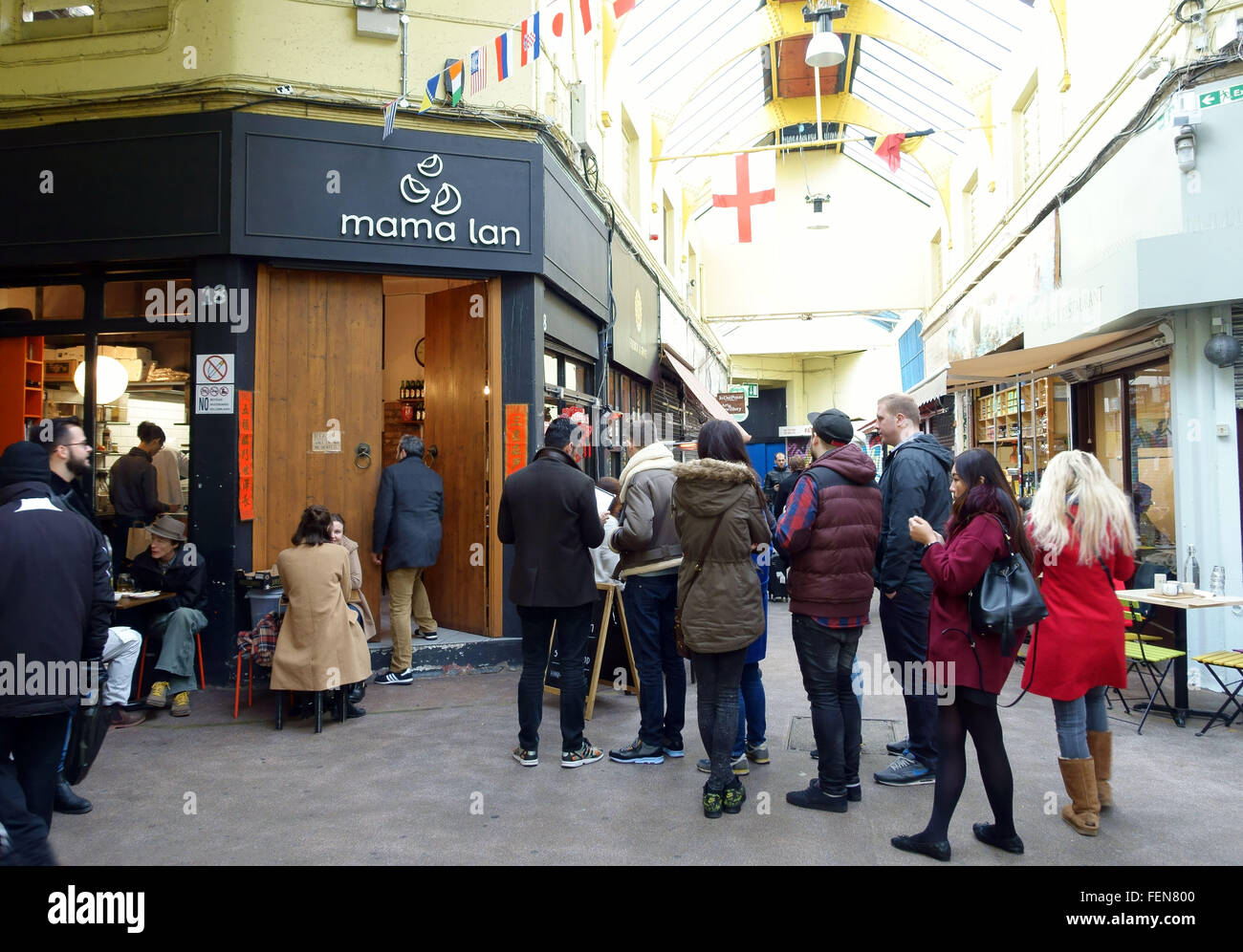 Customers queue outside Mama Lan Chinese restaurant in Brixton Village ...