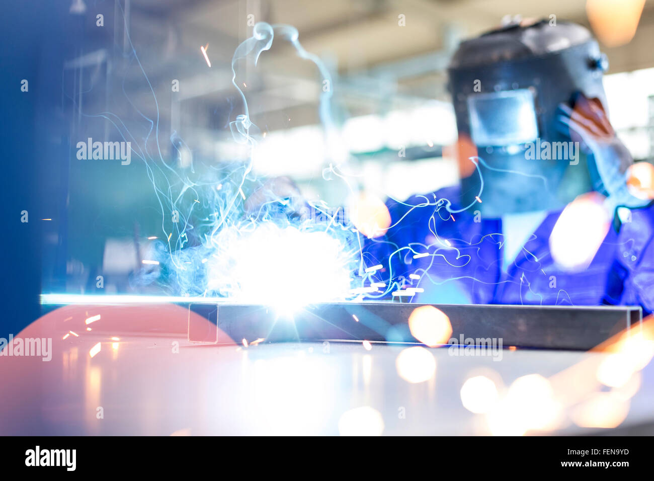 Welder using welding torch in factory Stock Photo - Alamy