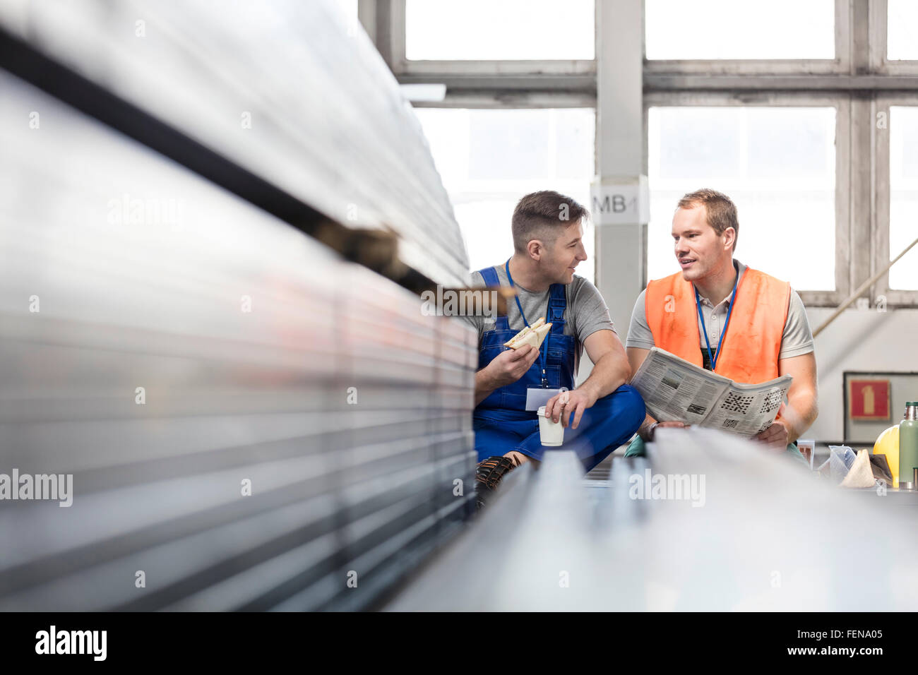 Workers enjoying coffee break in steel factory Stock Photo - Alamy