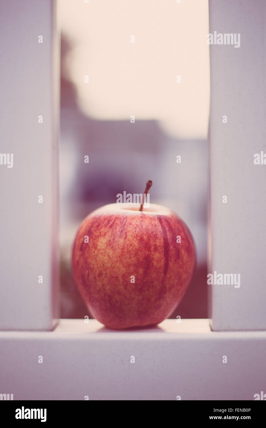 Apple framed on white fence Stock Photo - Alamy
