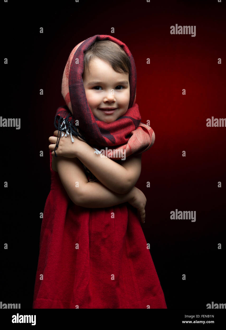 Cute child shivering in the cold isolated on black Stock Photo - Alamy