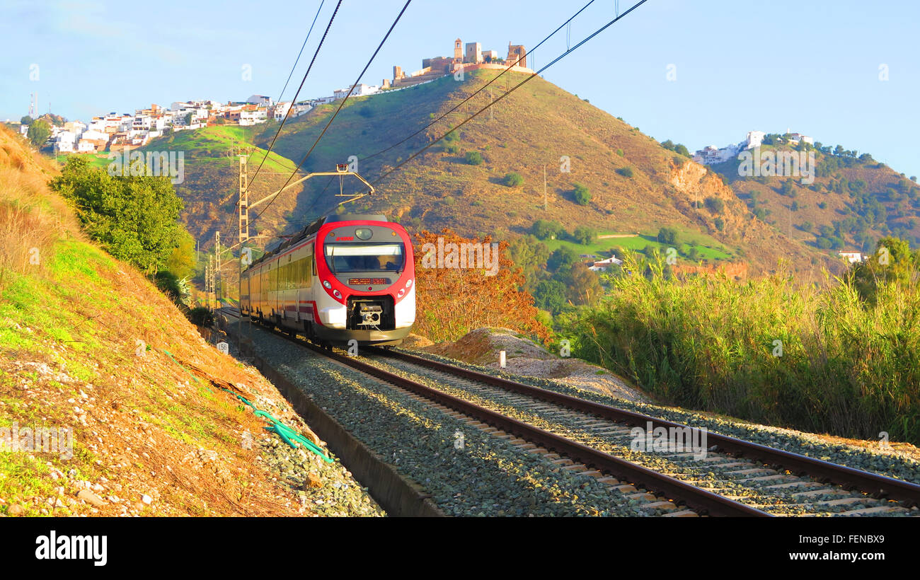 Local train passing below Alora Arabic Castle on a hazy morning Stock ...