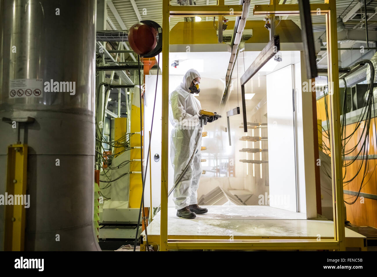 Worker operating machinery in factory Stock Photo - Alamy