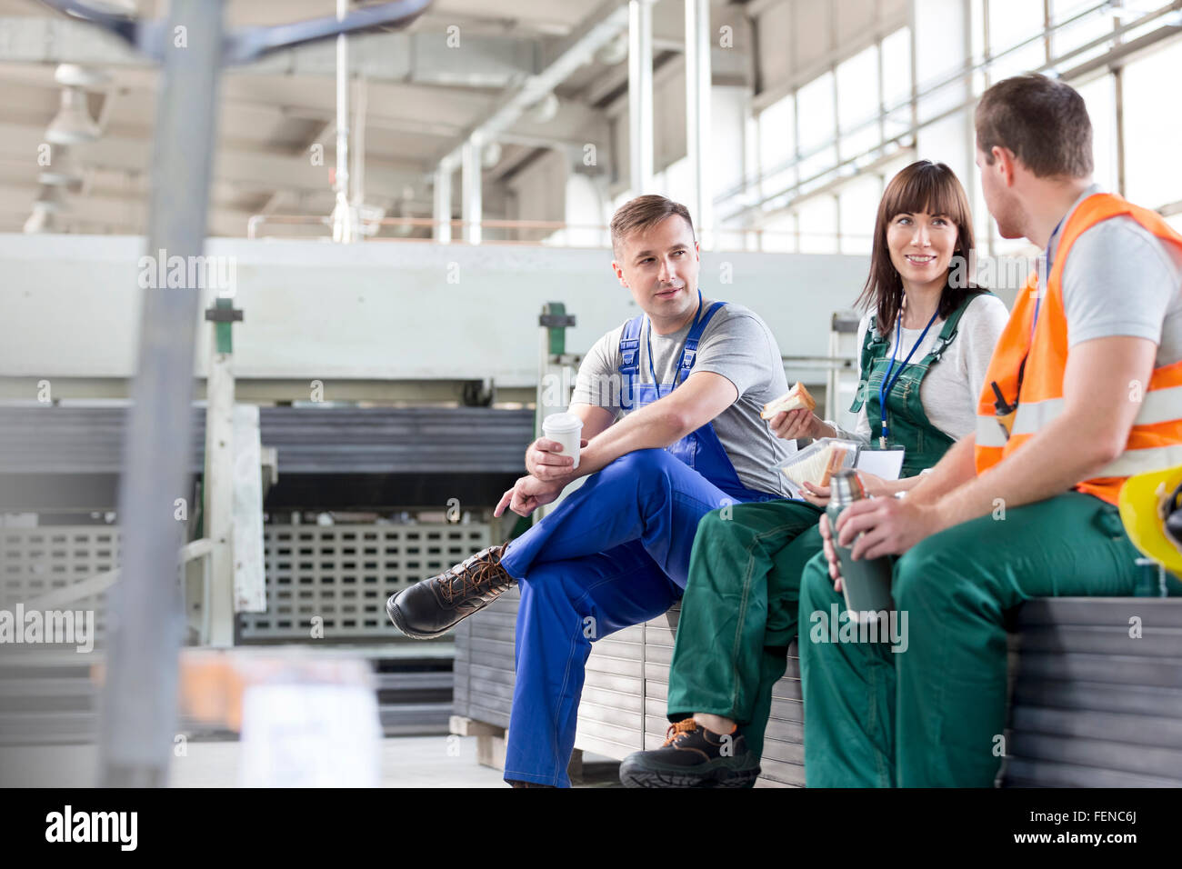 Workers enjoying coffee break in factory Stock Photo - Alamy