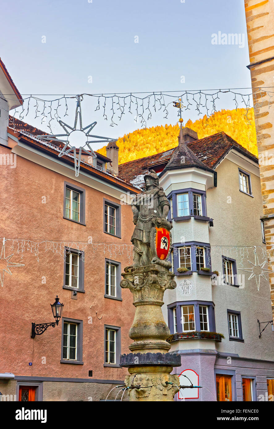 Fountain at the Church of St Martin at sunrise in Chur. Chur is the ...