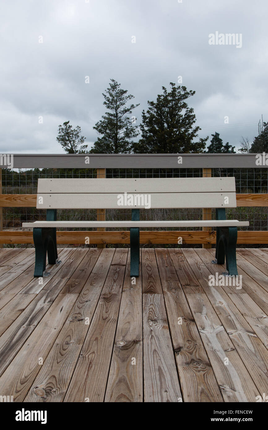 Bench on a boardwalk by the ocean Stock Photo - Alamy