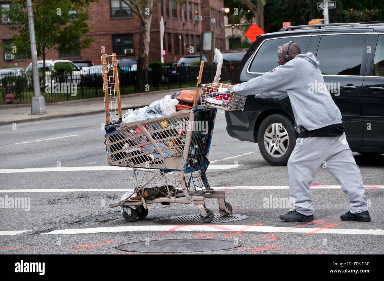 Homeless man pushing shopping trolley in New York City streets Stock ...