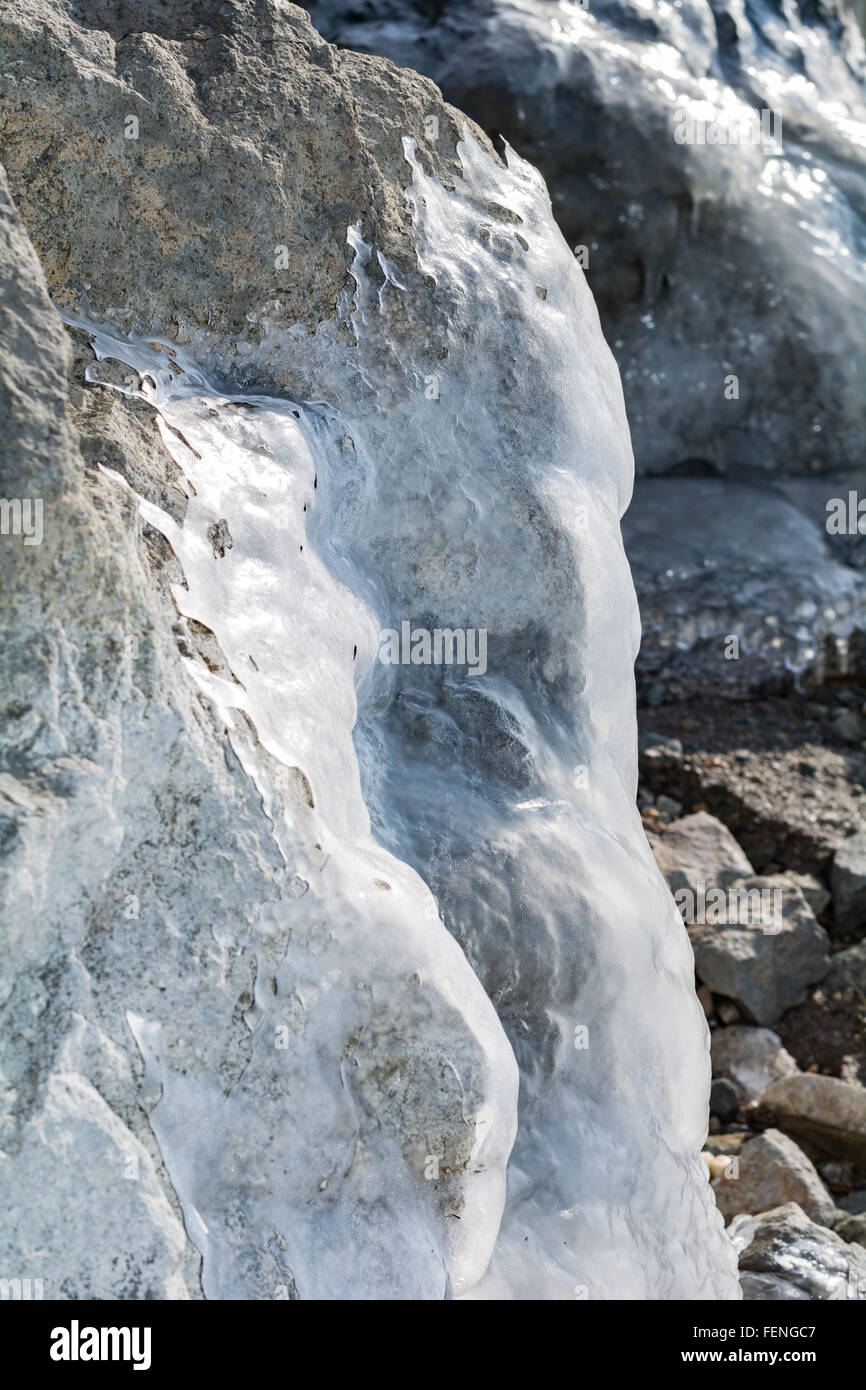 Frozen rocks with ice in the winter lake Stock Photo - Alamy
