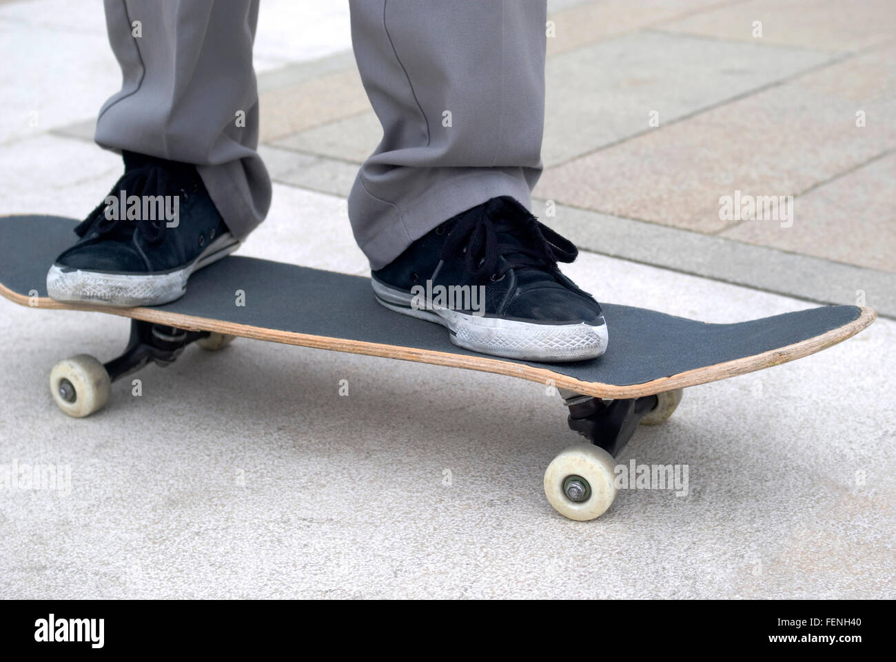 Boy's foot stepping on skateboard Stock Photo - Alamy