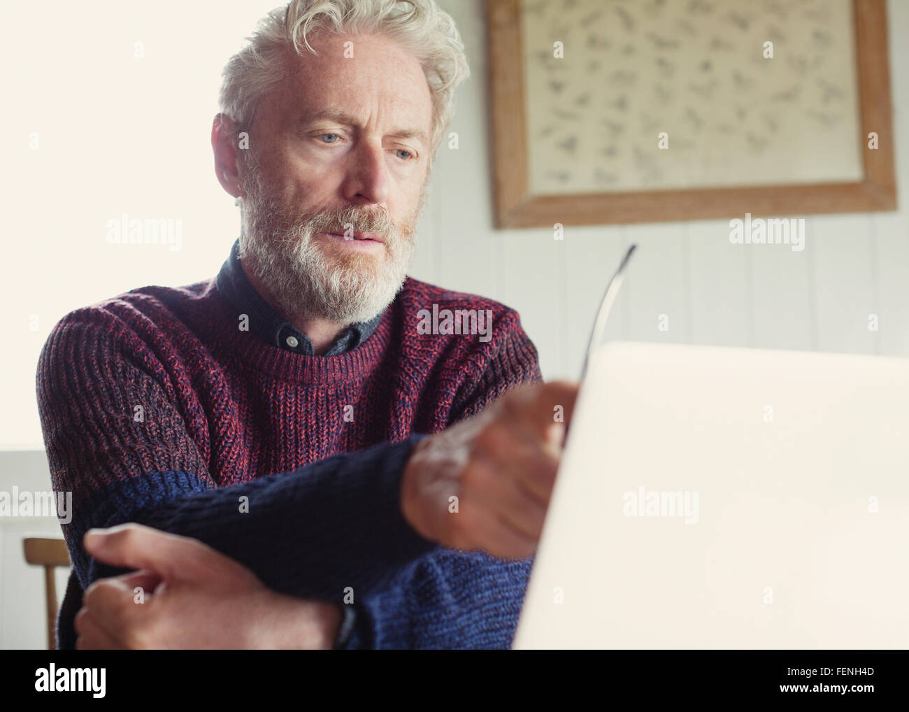 Serious man using laptop Stock Photo - Alamy