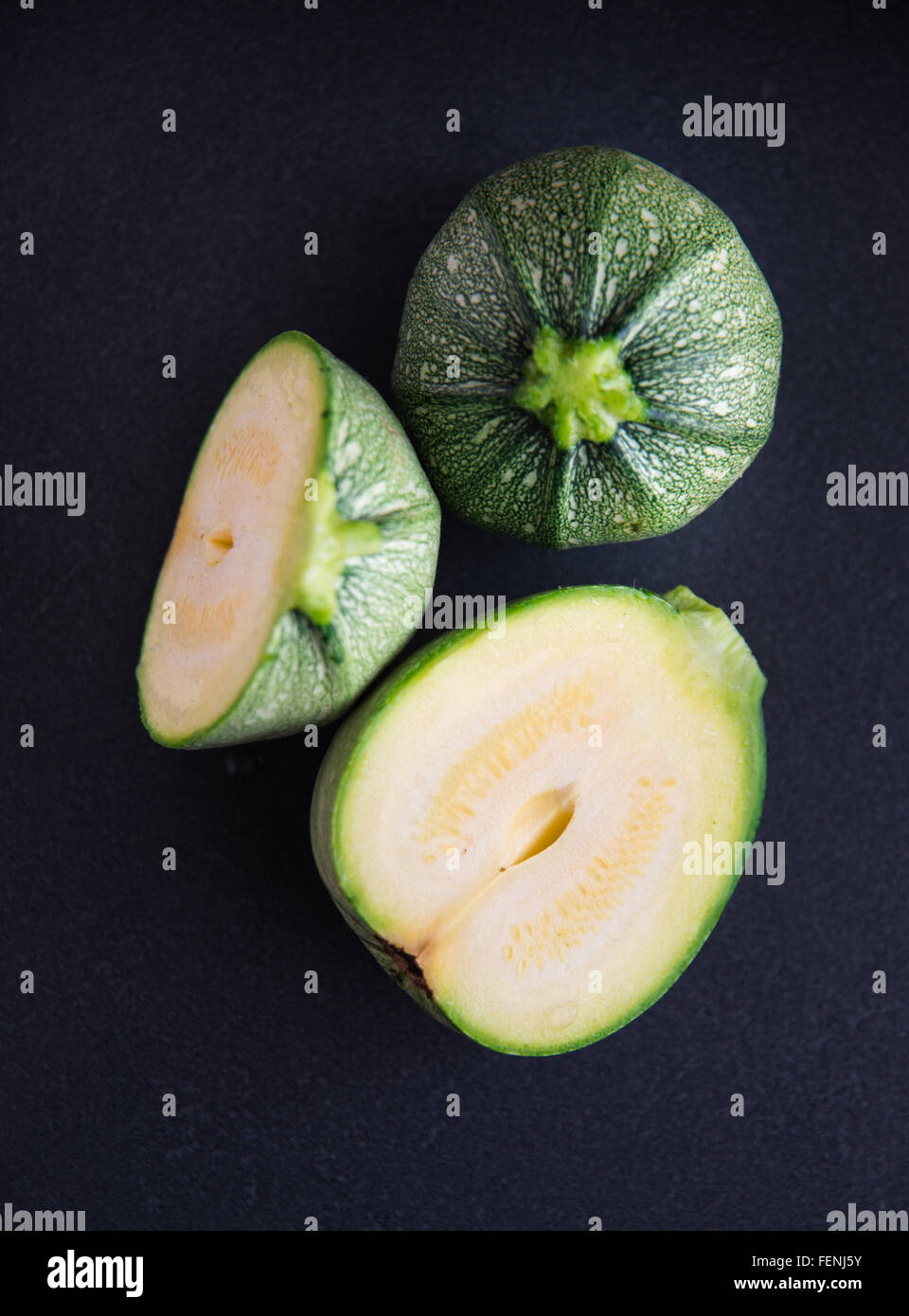 round zucchini courgette still life composition , on dark background ...