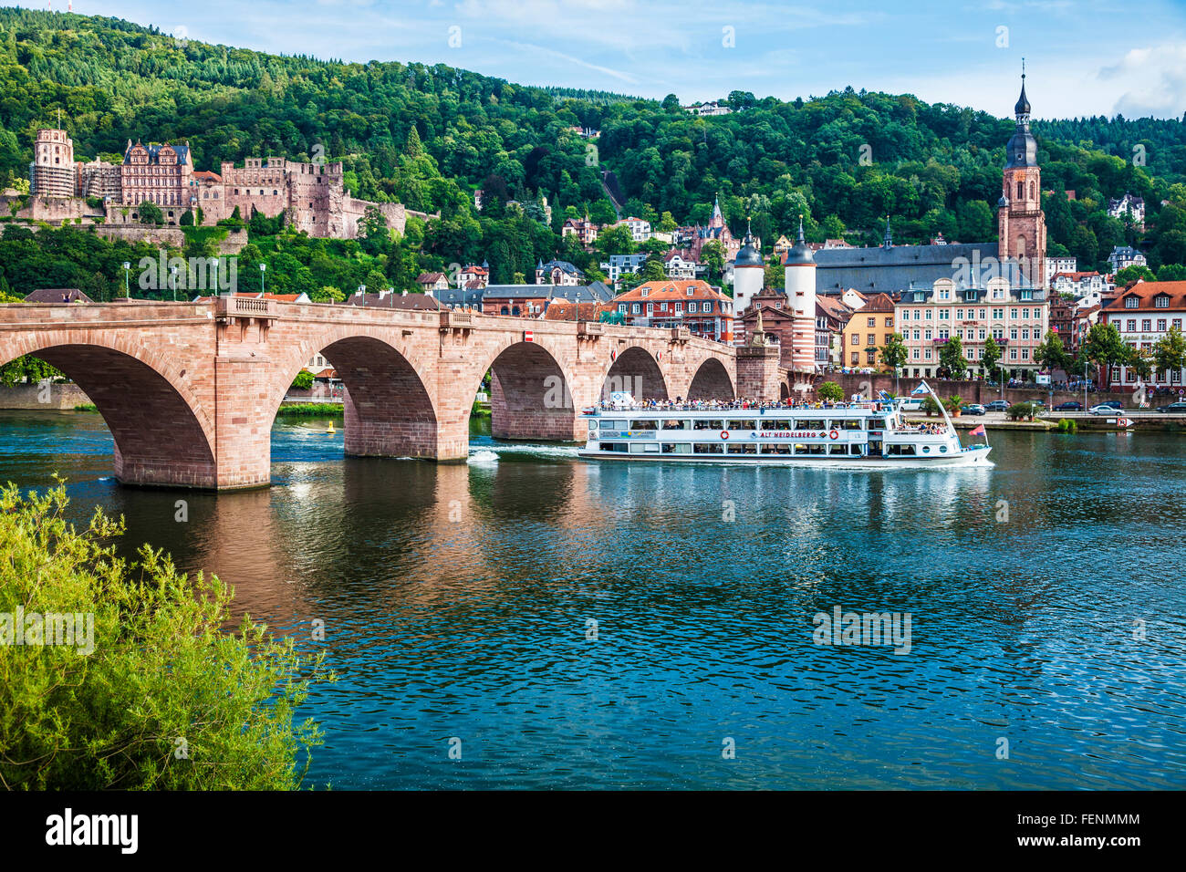 A tourist cruise boat passes under the Karl Theodor Bridge on the River ...