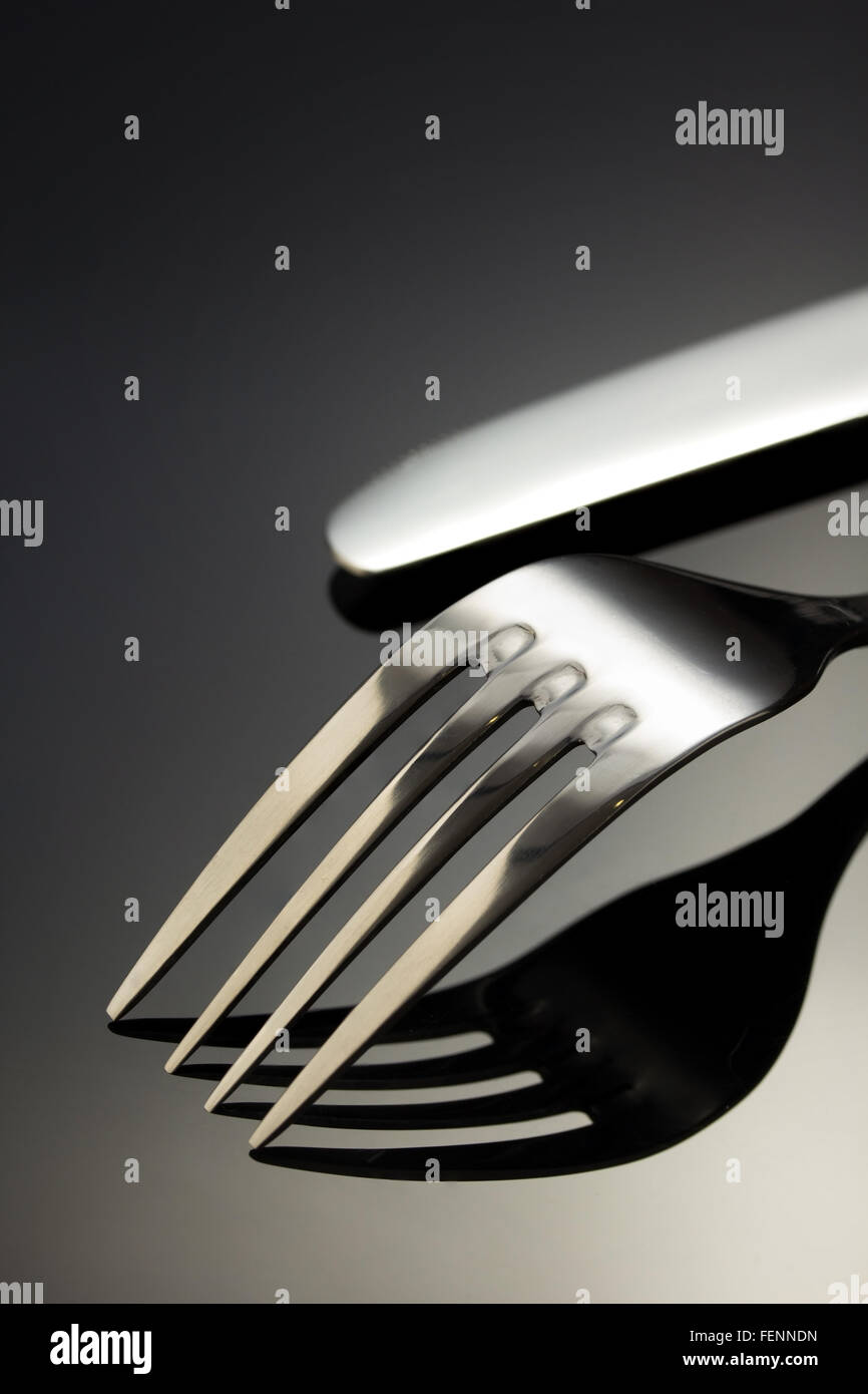 knife and fork on black background Stock Photo - Alamy