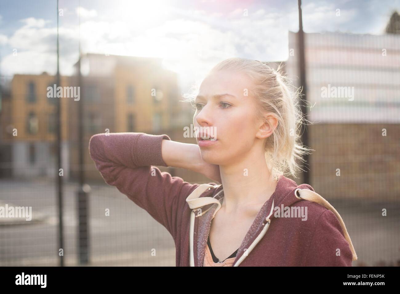 Young woman looking away, outdoors Stock Photo - Alamy
