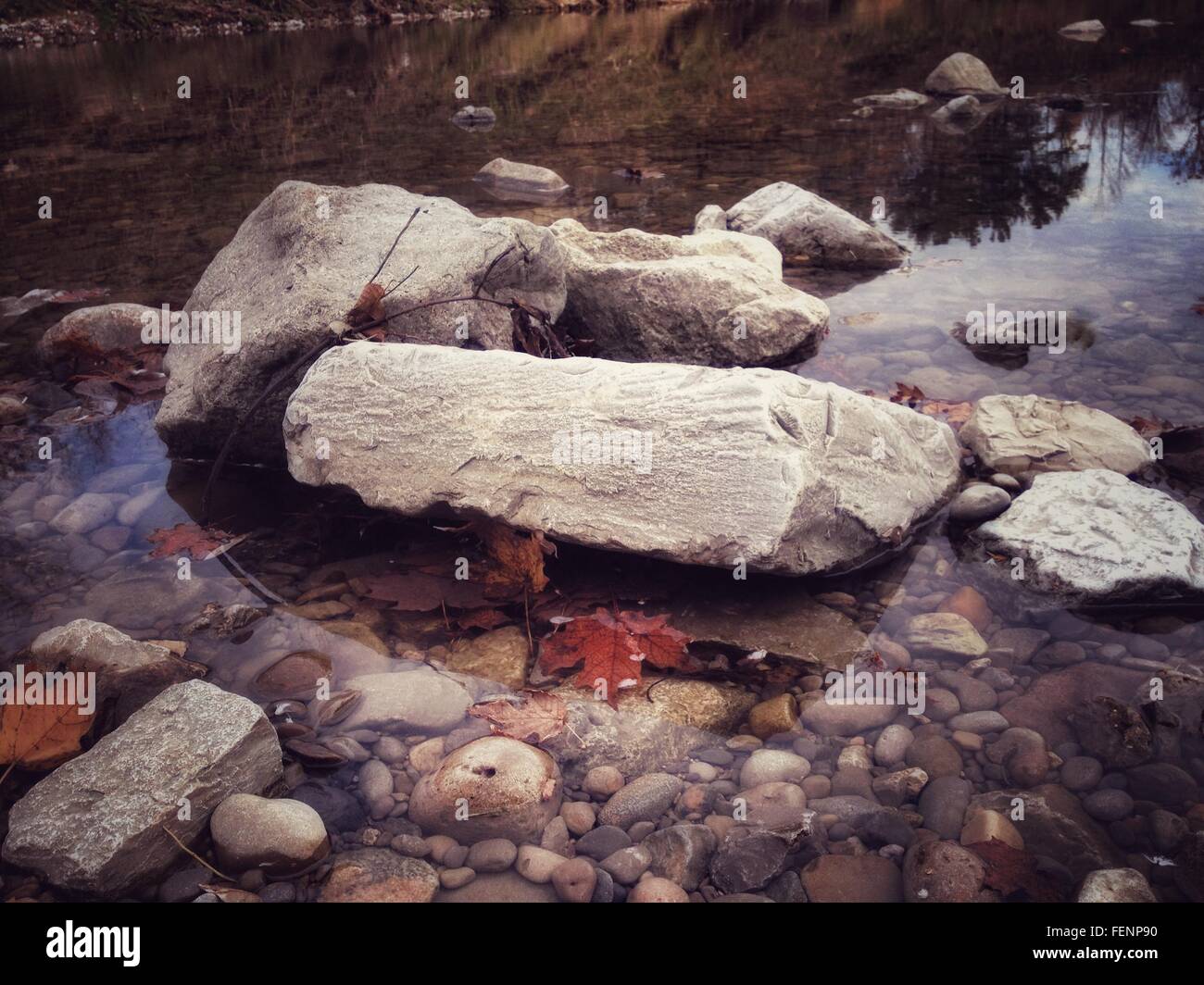 Large rocks in river with soft warm colors Stock Photo - Alamy