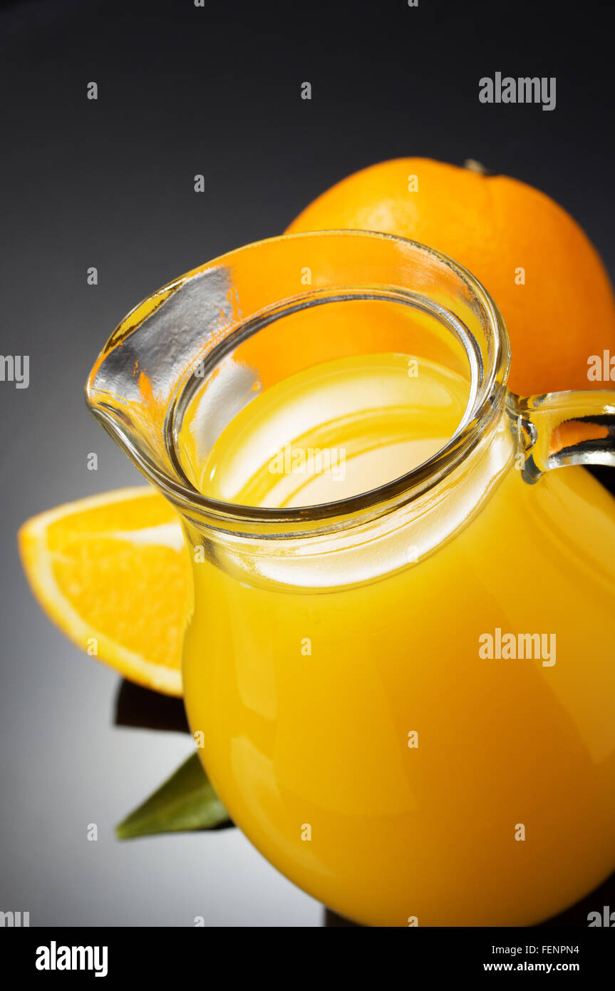 orange juice and fruit on black background Stock Photo - Alamy