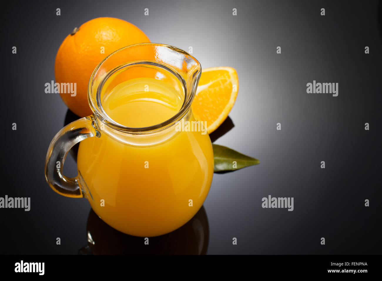 orange juice and fruit on black background Stock Photo - Alamy