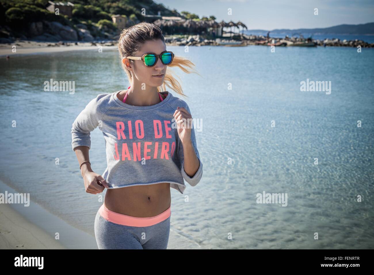 Female runner running on beach, Villasimius, Sardinia, Italy Stock ...