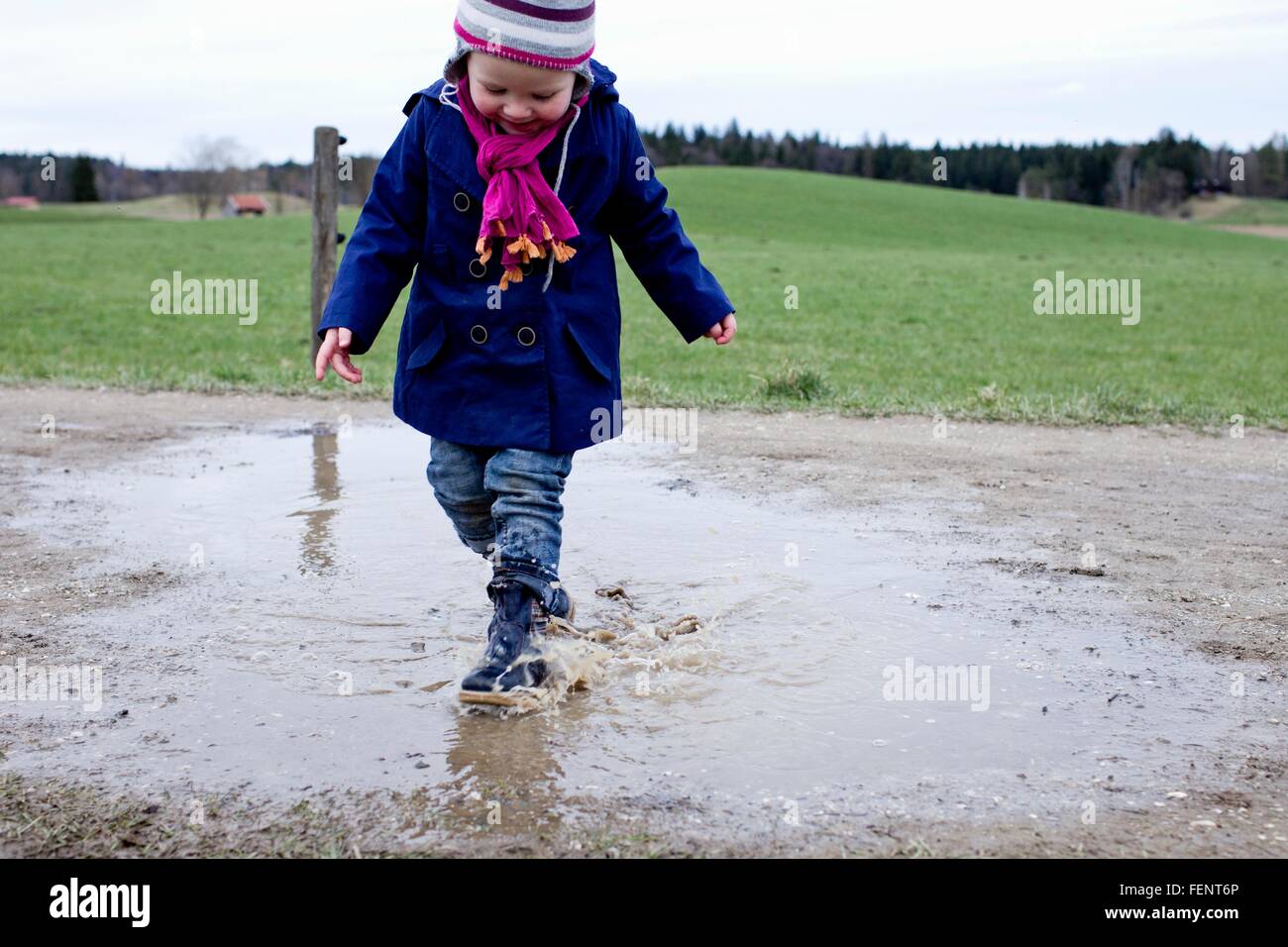 Girl splashing puddle hi-res stock photography and images - Alamy