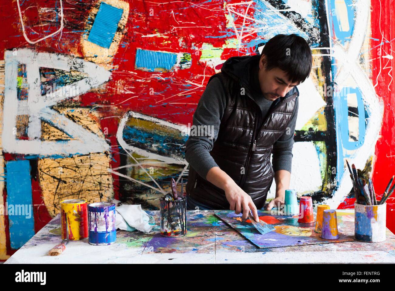 Male artist creating painted artwork Stock Photo - Alamy