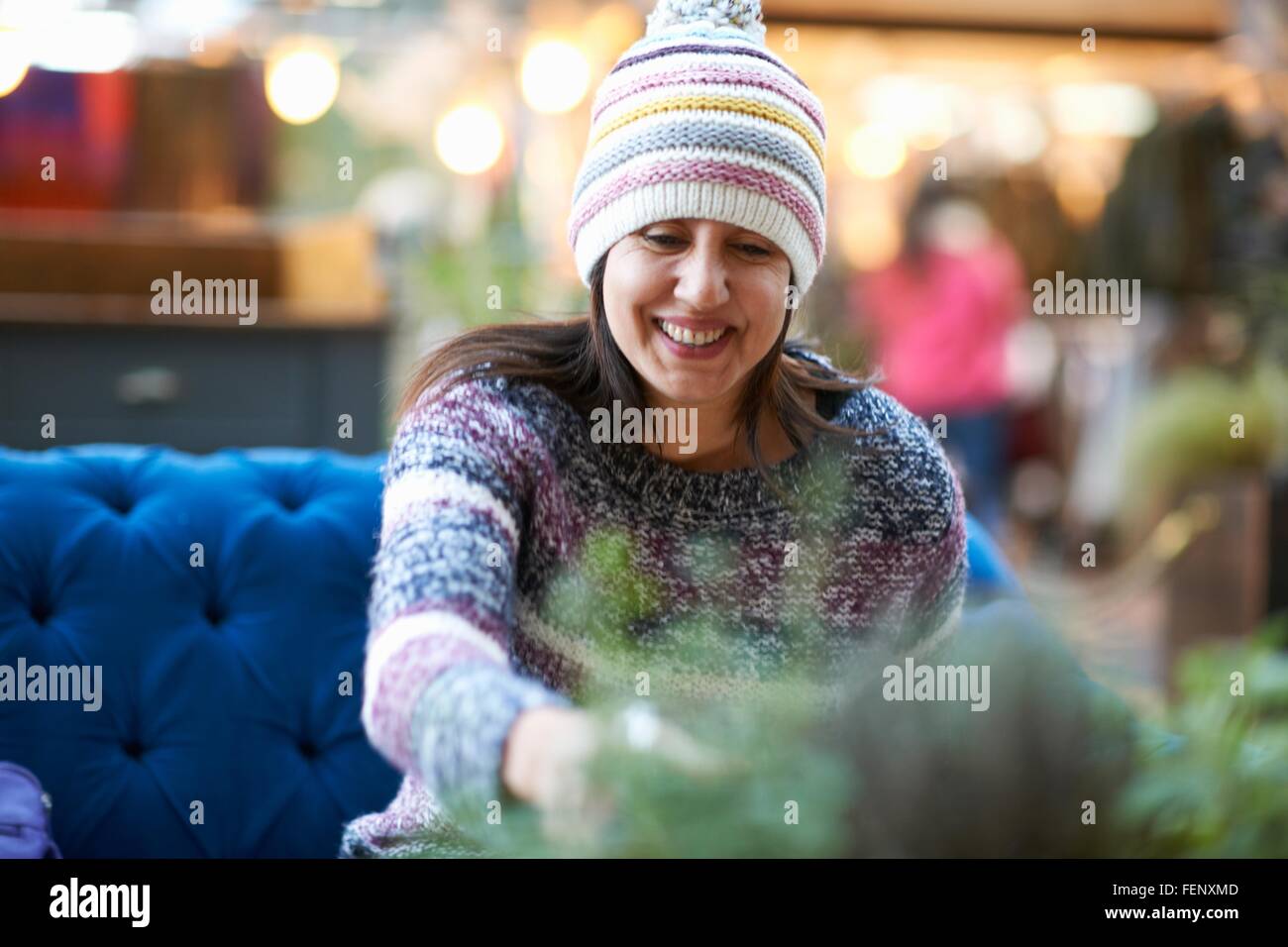 Mature woman wearing knit hat drinking red wine at sidewalk cafe Stock ...