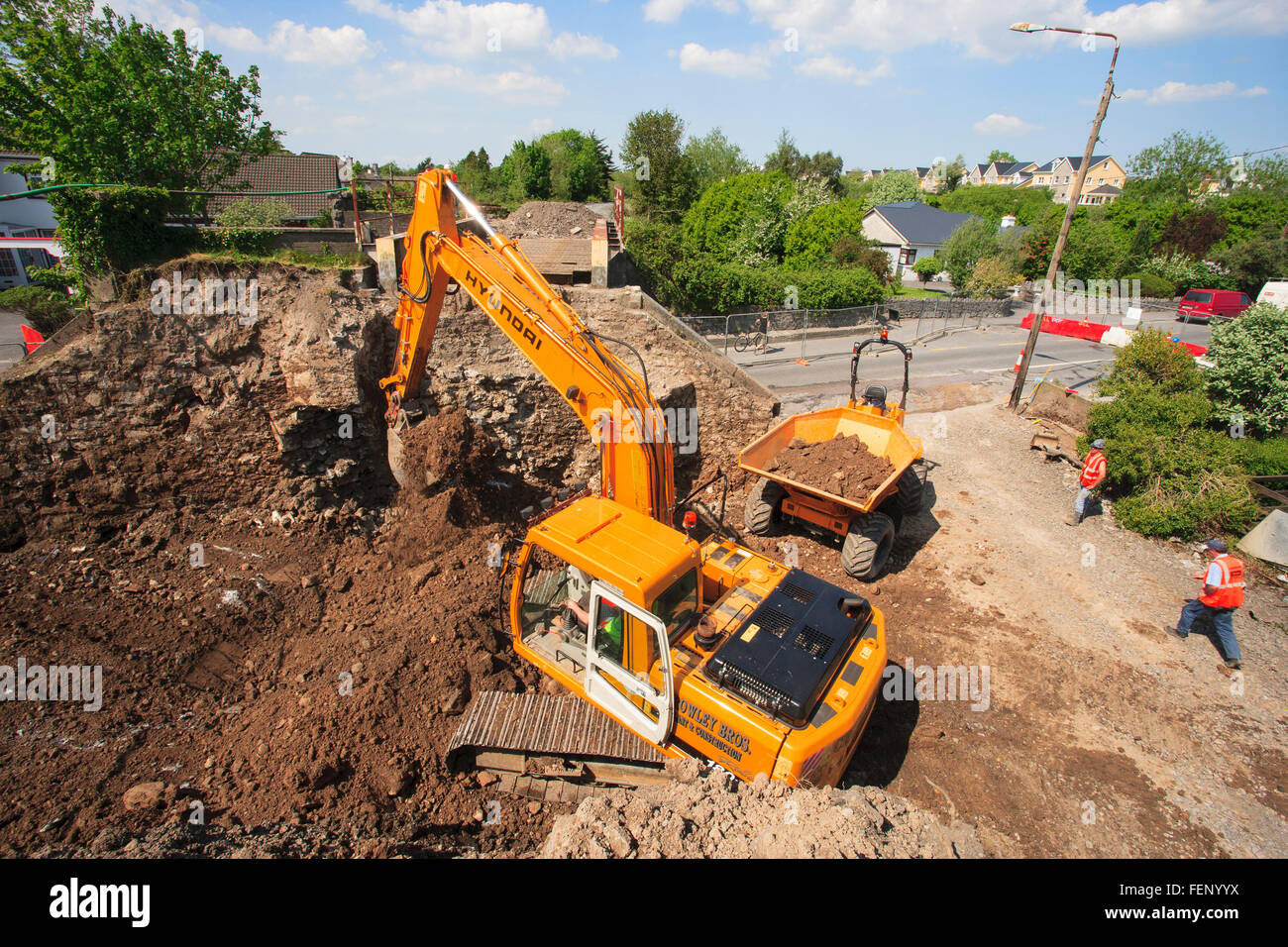 construction workers with earthmover Stock Photo - Alamy