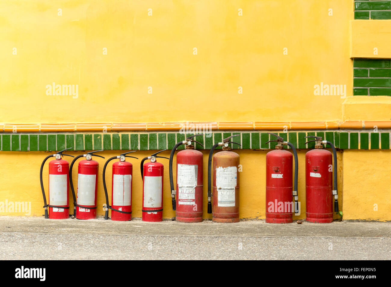 Row of fire extinguishers against a wall in Hanoi, Vietnam Stock Photo ...